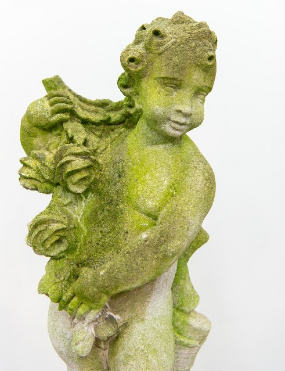 Concrete statue of cherub holding roses on base