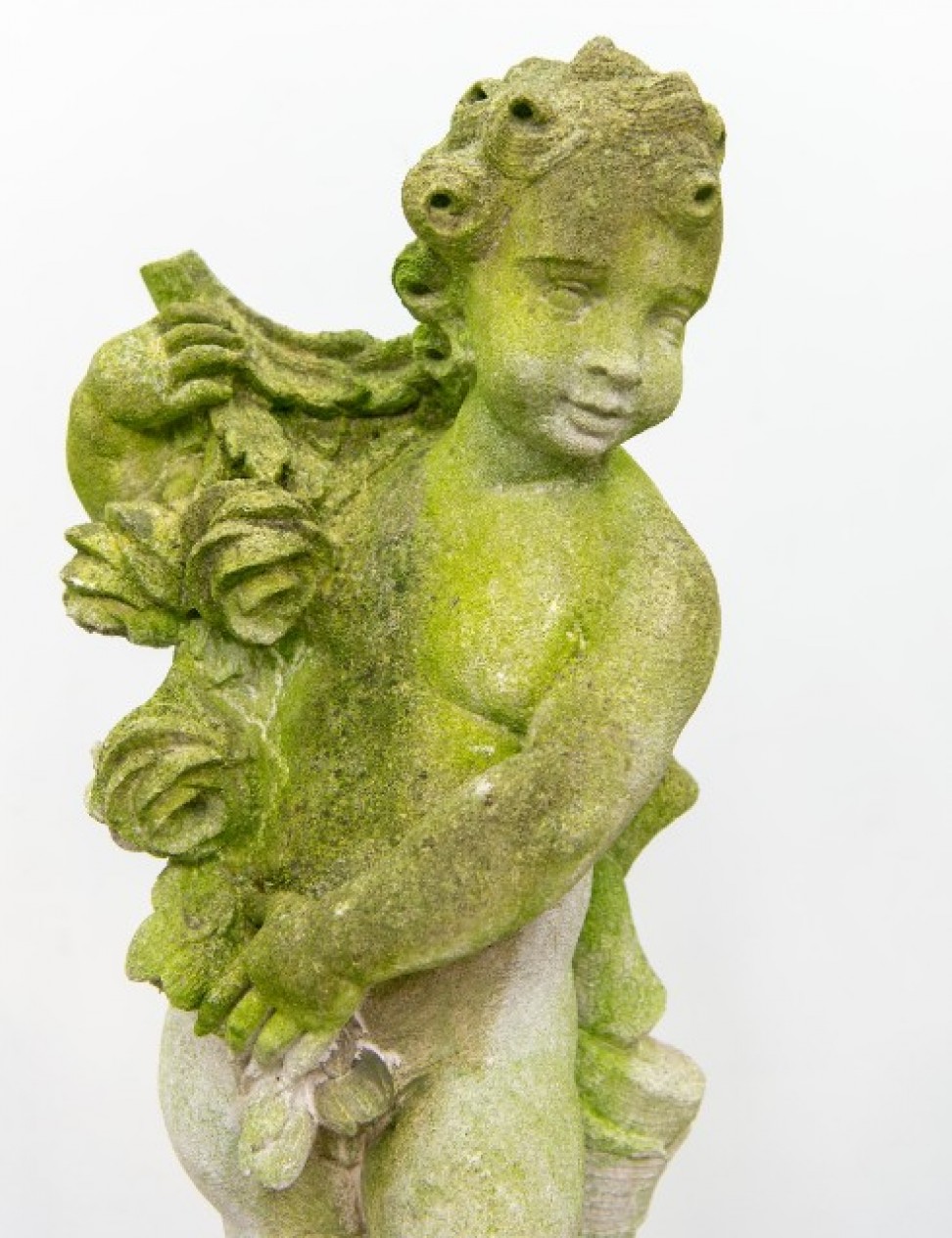 Concrete statue of cherub holding roses on base